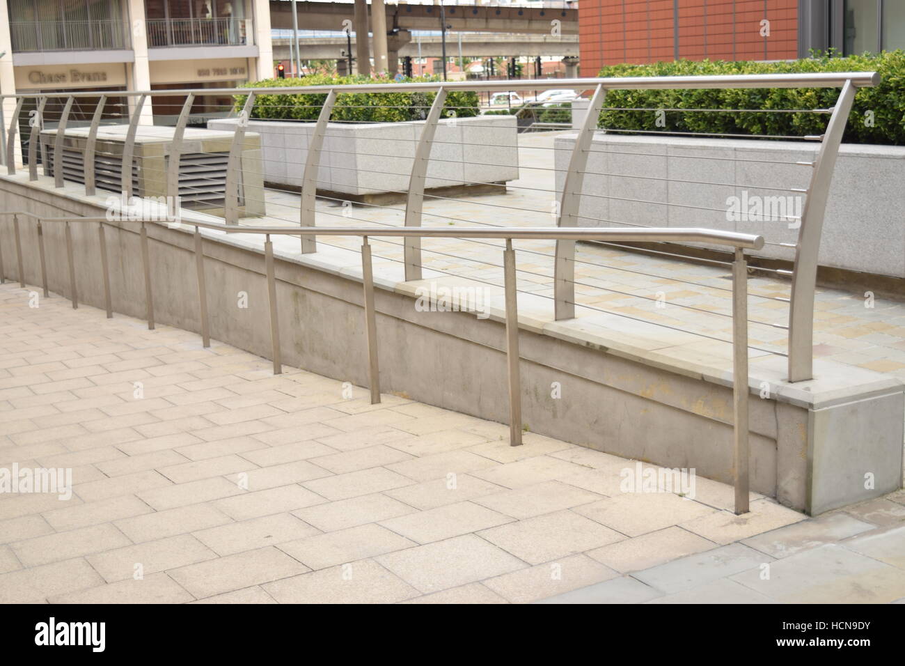 Sliver metallic railing leading to the shopping center in Canary wharf ...