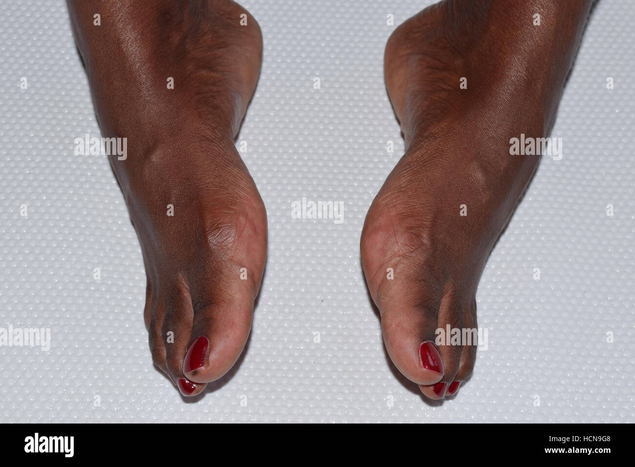 Beautiful female feet apart on a white background Stock Photo - Alamy