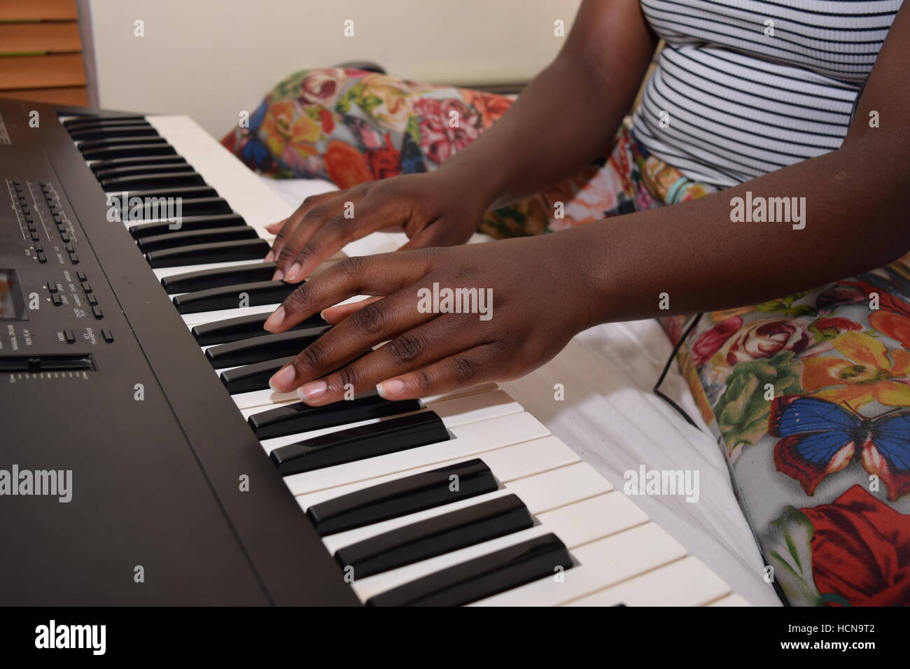 Young girl's hands on the keyboard practicing Stock Photo - Alamy