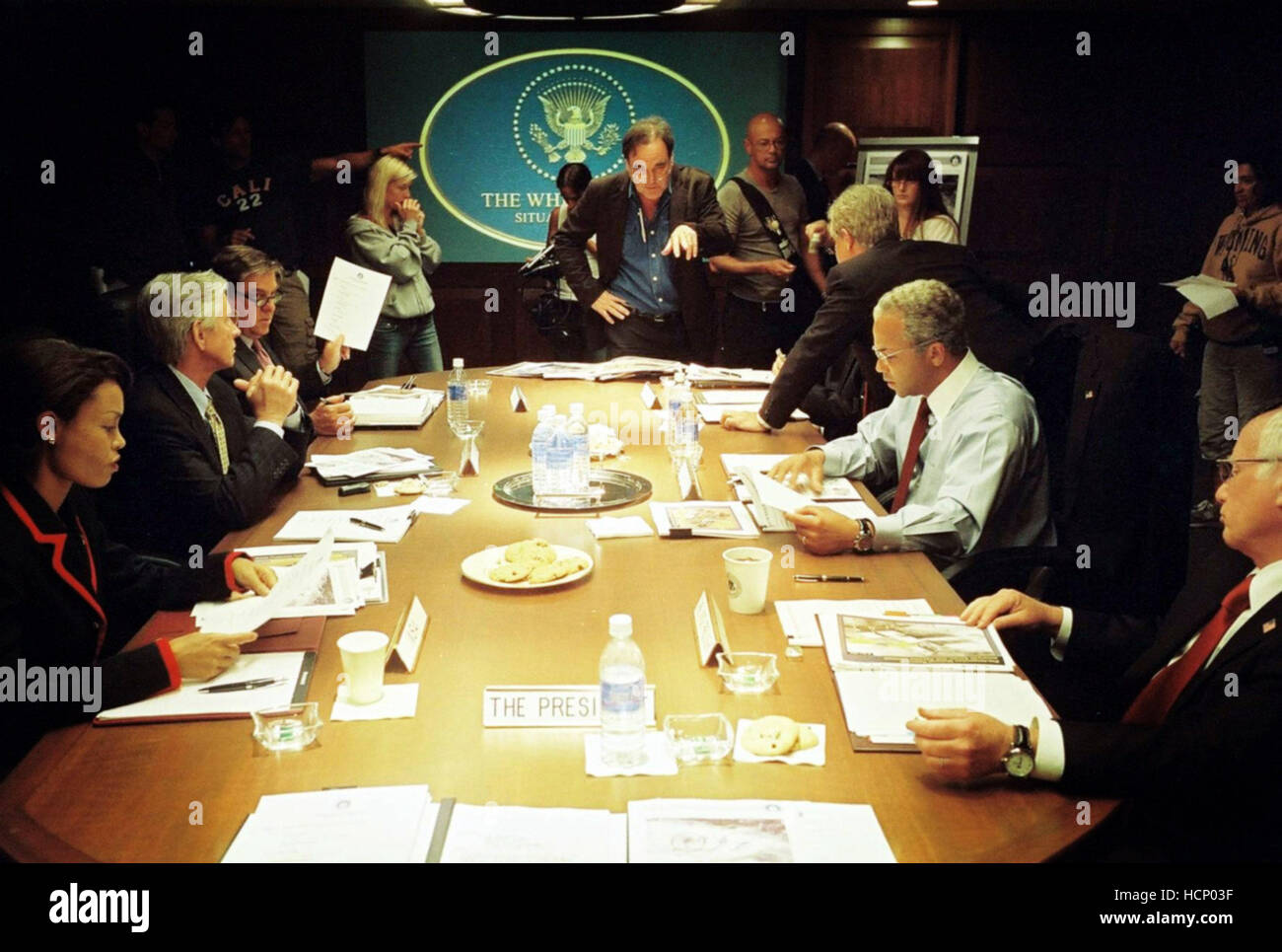 W., (aka W), standing in center: director Oliver Stone, seated at table ...