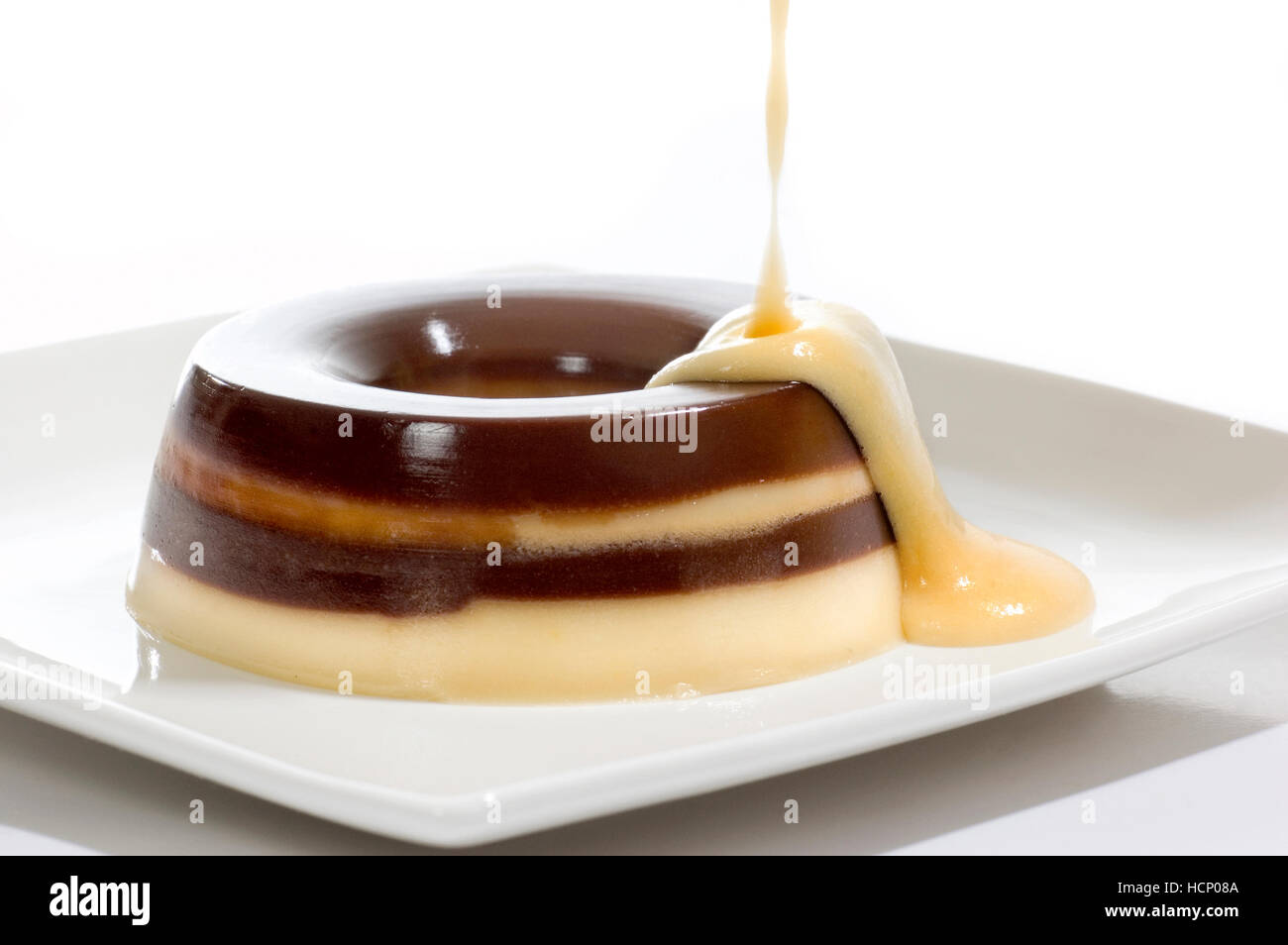 Pudding cover with cream on white background Stock Photo - Alamy