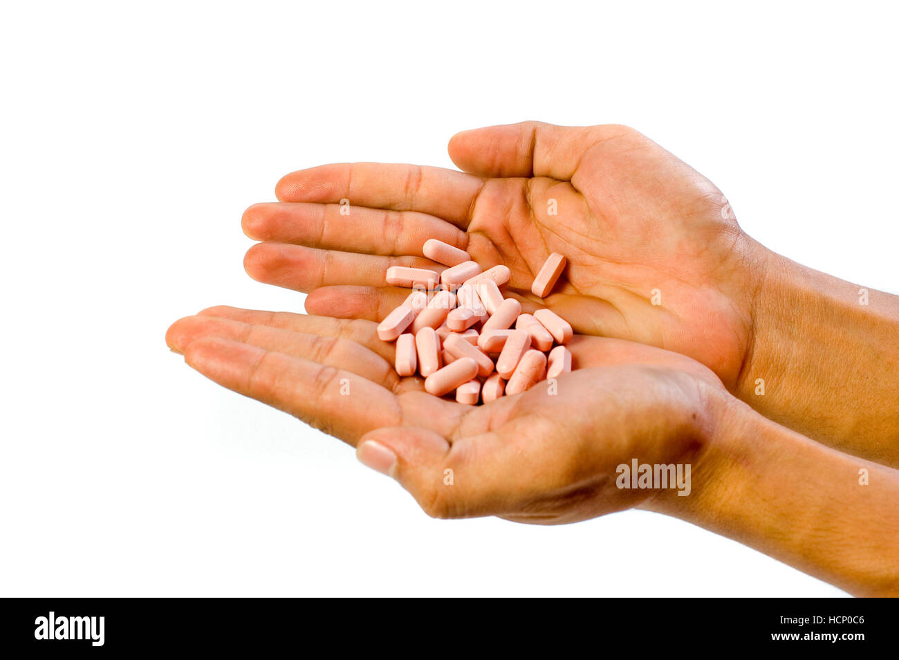 A lots of tablets in man's two hands on white background Stock Photo ...