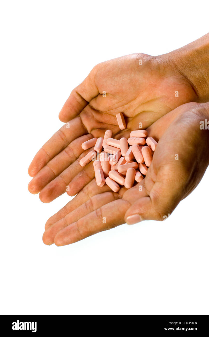 A lots of tablets in man's two hands on white background Stock Photo ...