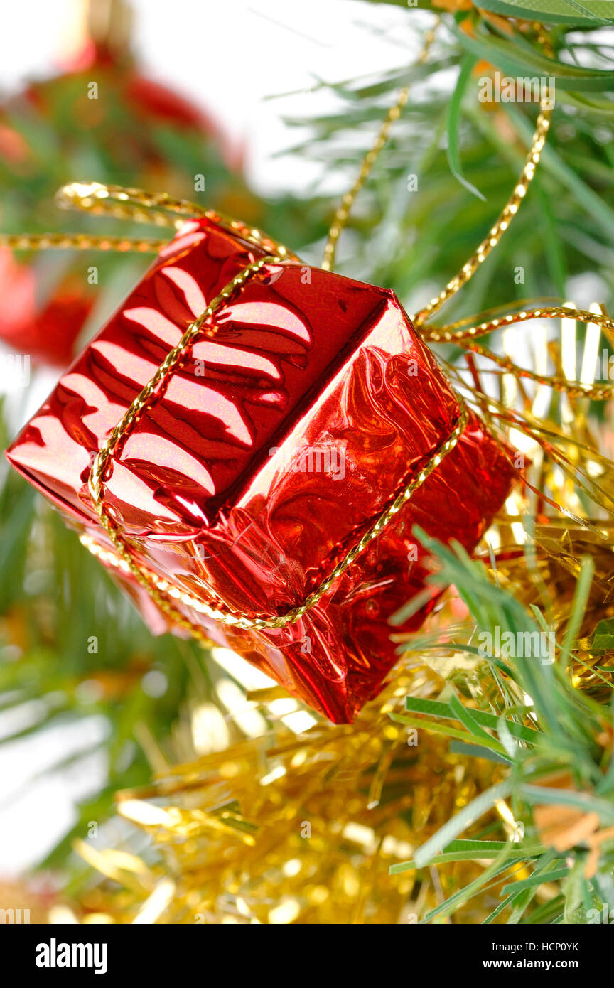 Christmas gift box hanging on tree over white background Stock Photo ...