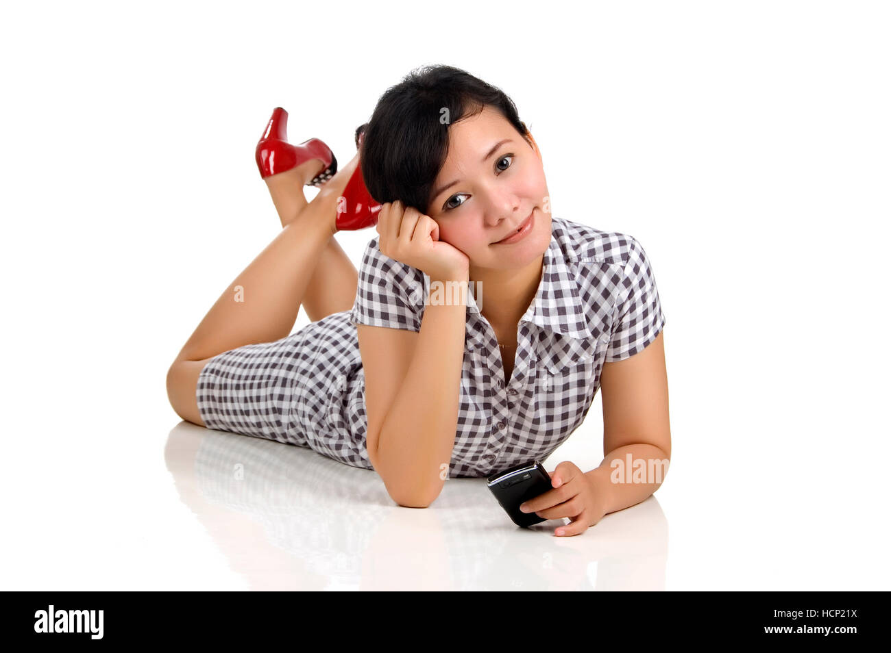 Beautiful woman and a phone lying on white background Stock Photo - Alamy