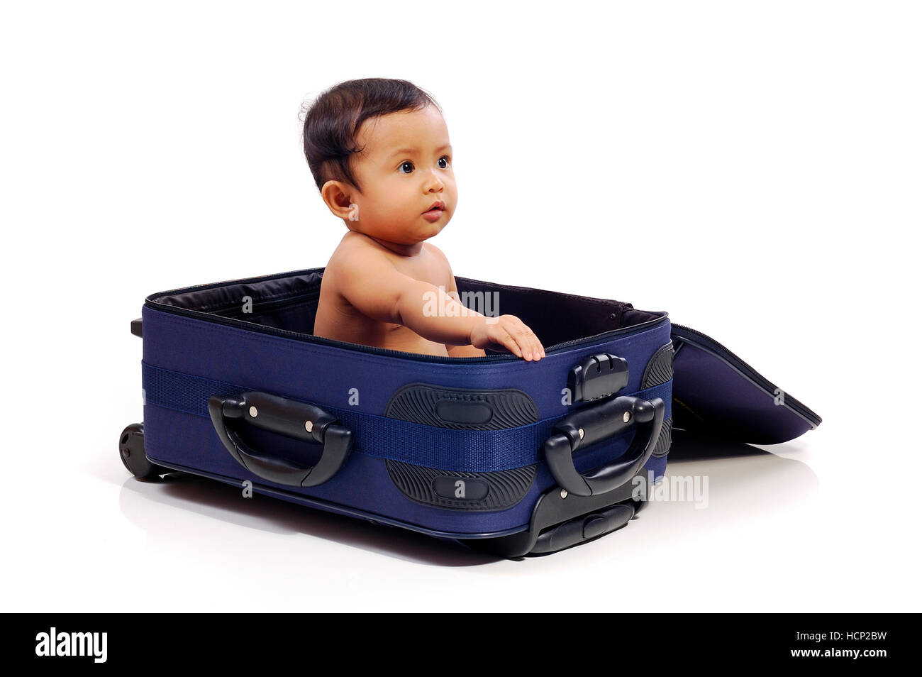 Baby girl in the blue suitcase on white background. Ready to travel ...
