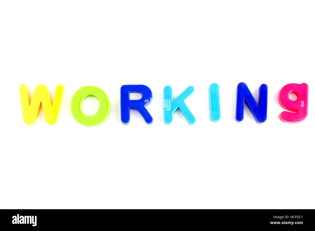 Word working isolated on white background made from colorful toys ...