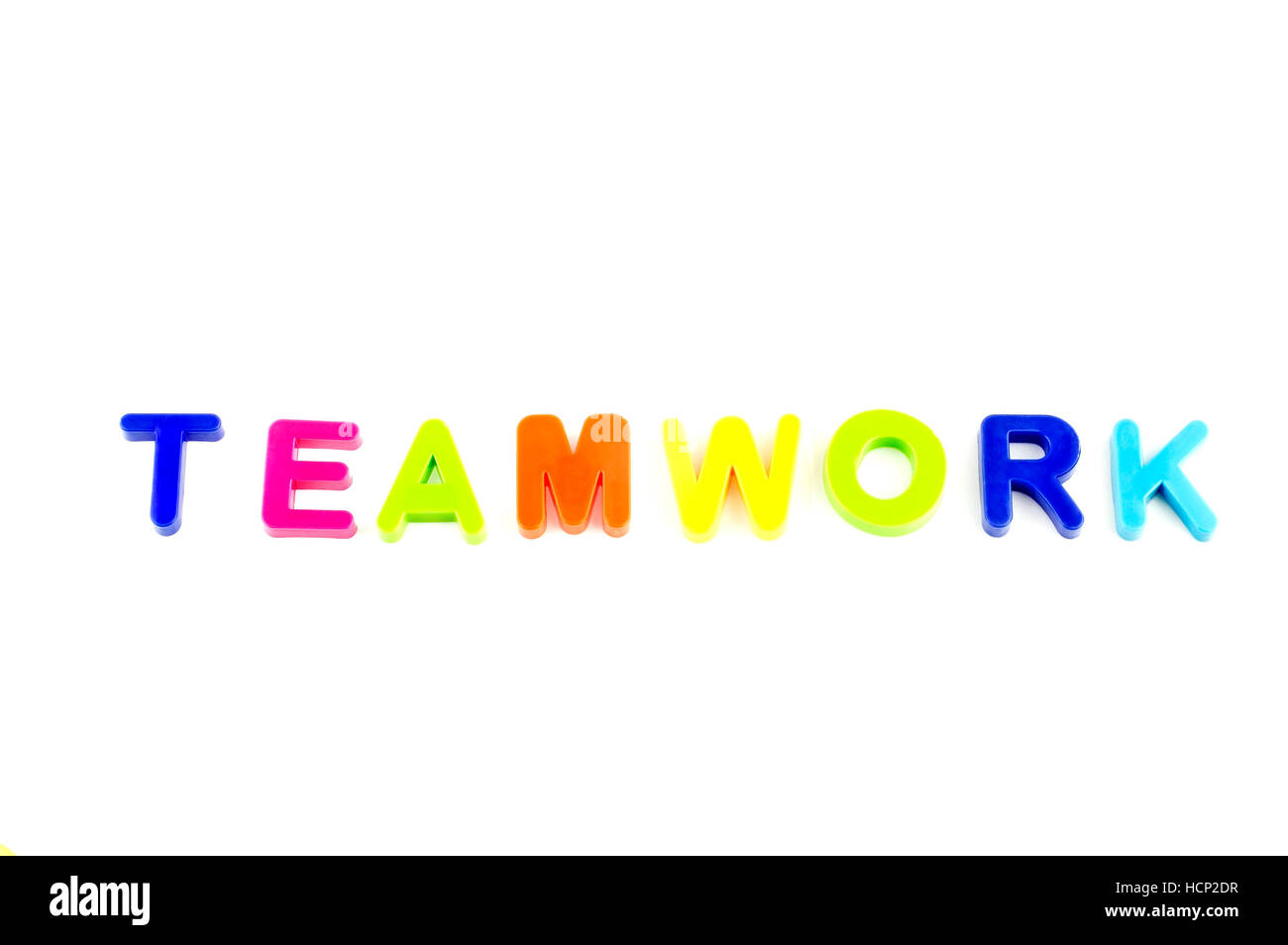 Word teamwork isolated on white background made from colorful toys ...