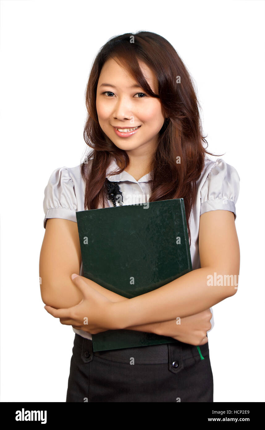 Beautiful college student holding book in her hand. She looks happy and ...