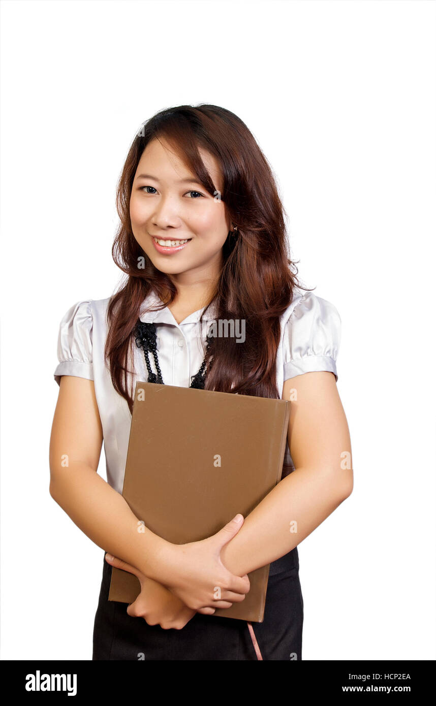 Beautiful college student holding book in her hand. She looks happy and ...