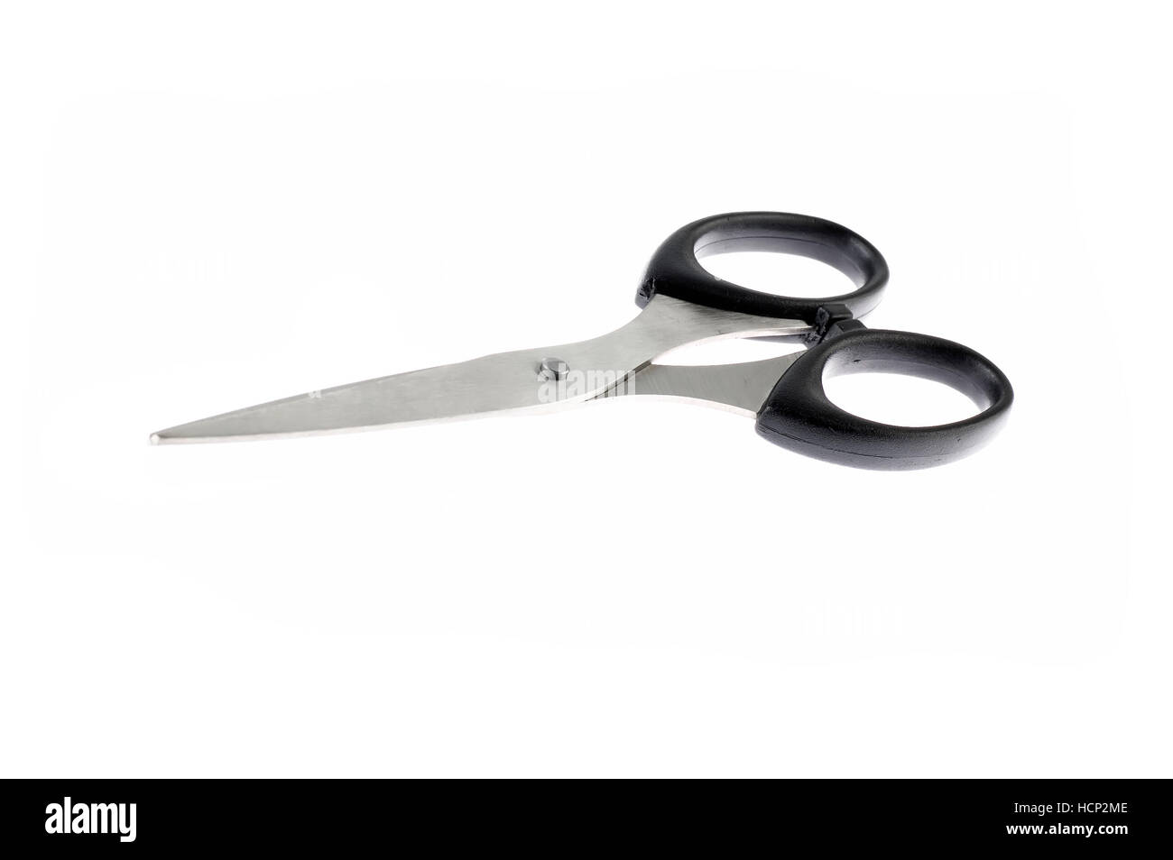 Scissors with black handle on white background Stock Photo - Alamy