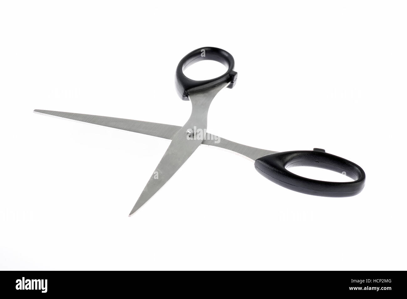 Open scissors with black handle on white background Stock Photo - Alamy