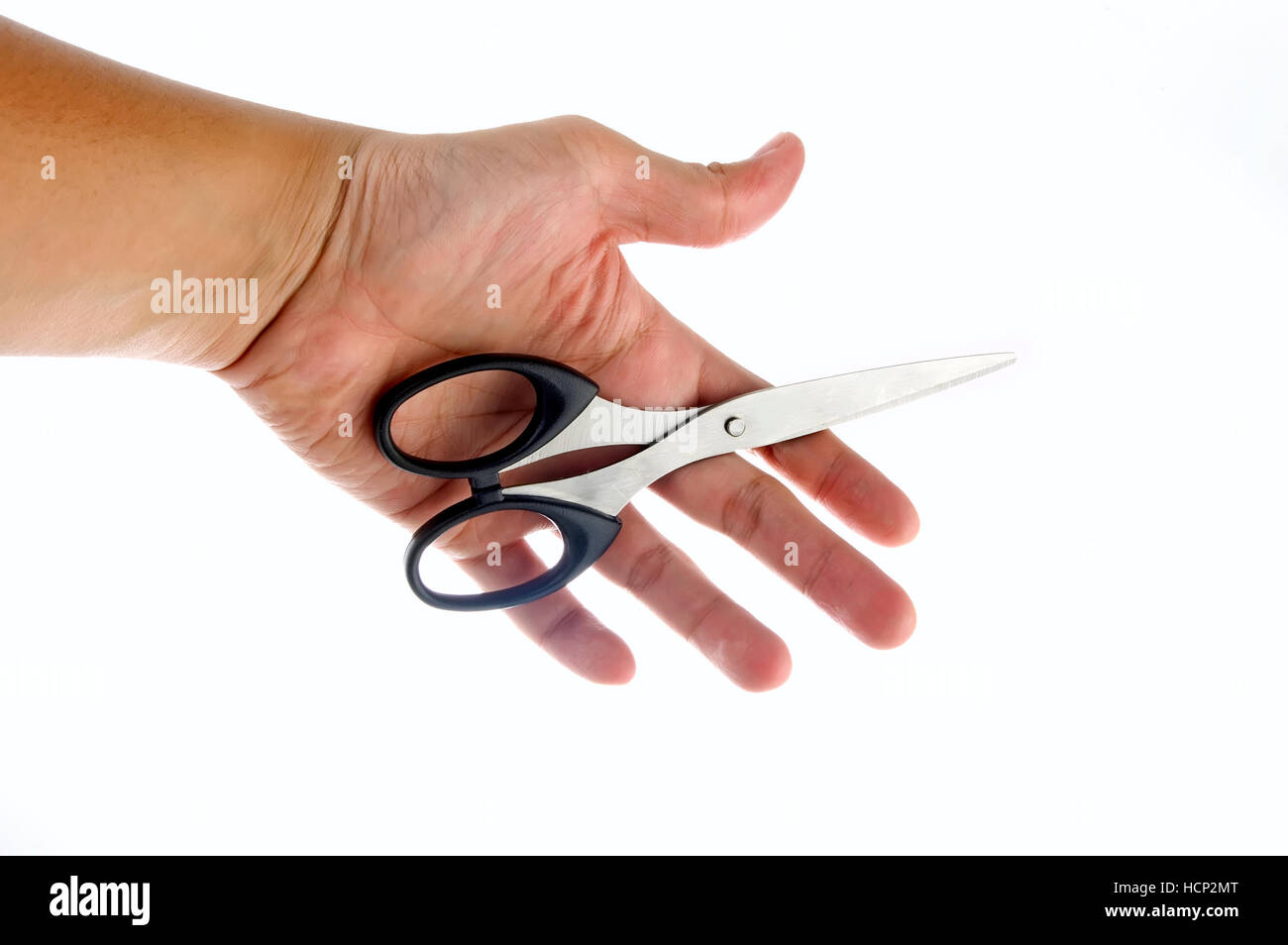 Scissors in hand on white background Stock Photo - Alamy