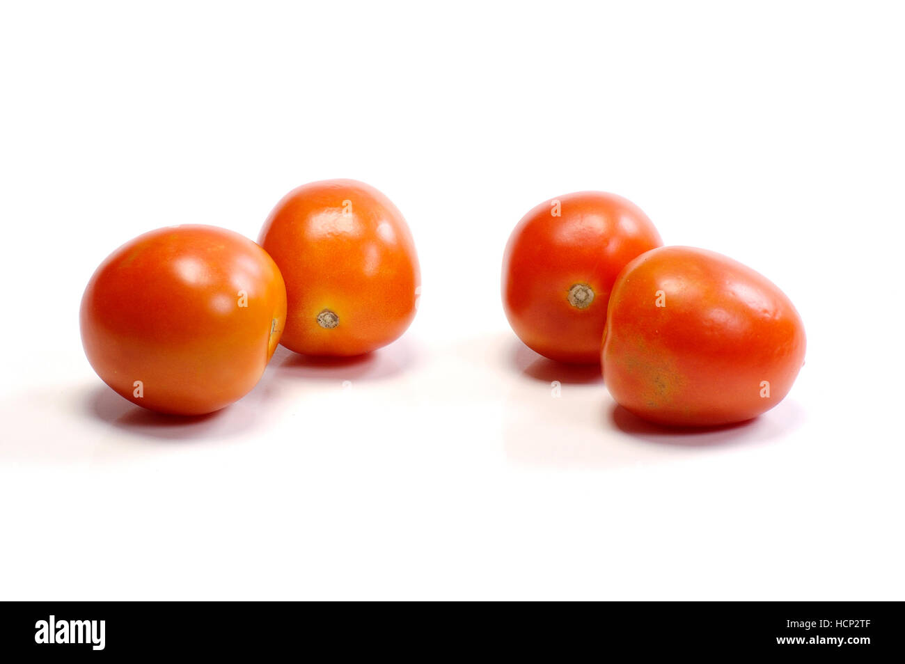Four tomatoes on white background. Look tasty and fresh Stock Photo - Alamy
