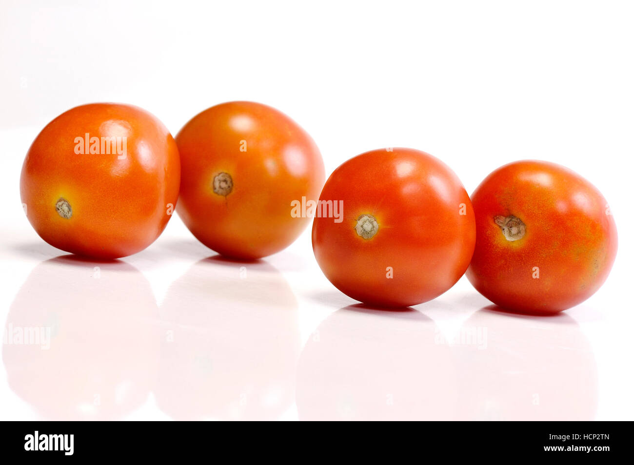 Four tomatoes on white background. Look tasty and fresh Stock Photo - Alamy