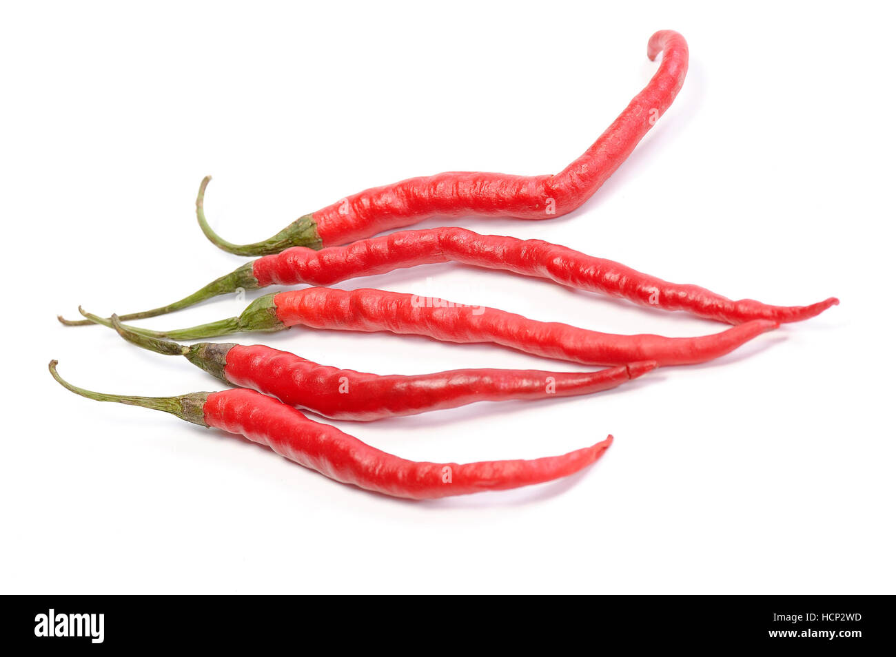 Five Red Hot Chili Peppers on White Background Stock Photo - Alamy