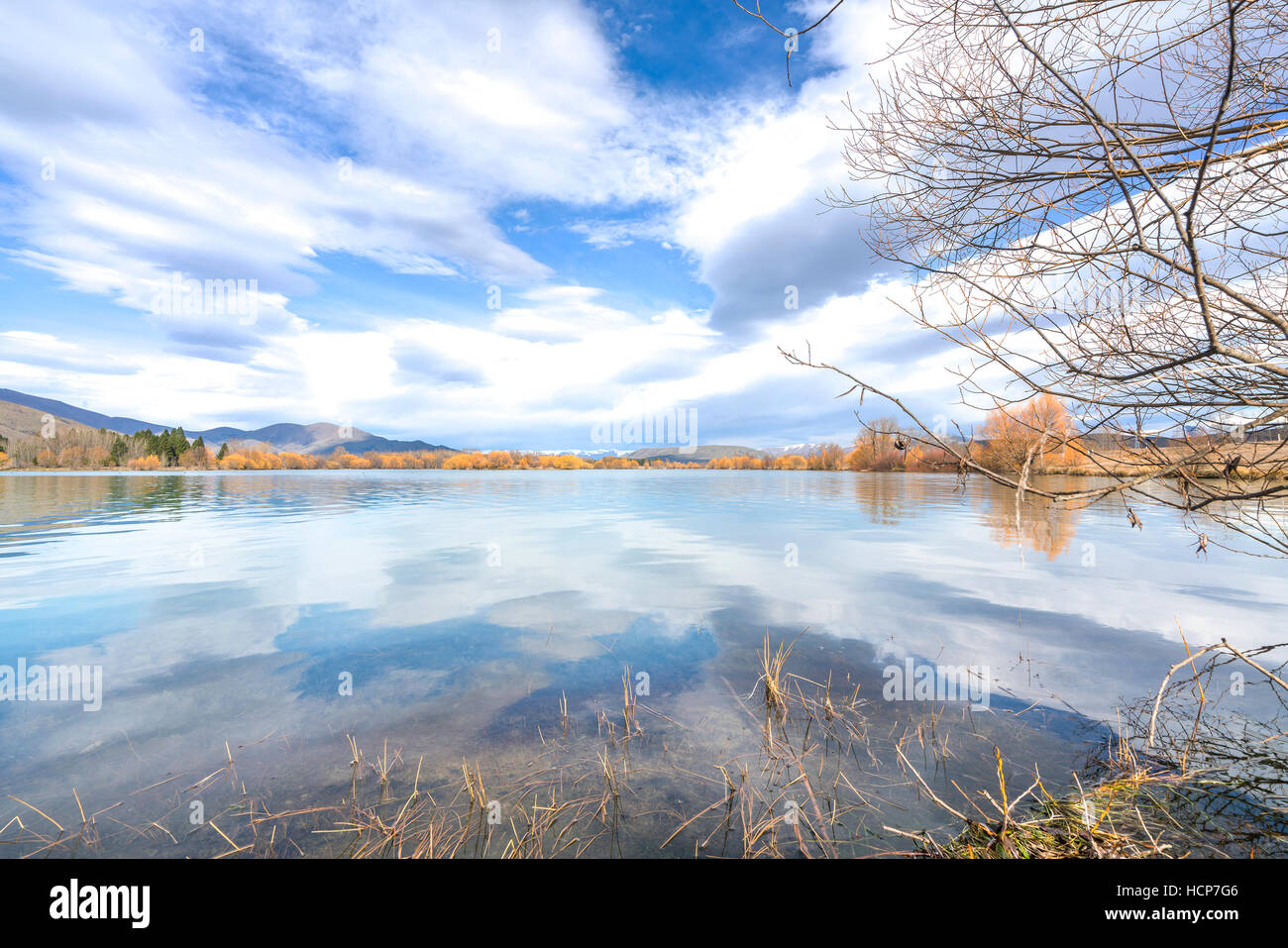 Lake water reflection with lenticular cloud skies Stock Photo - Alamy