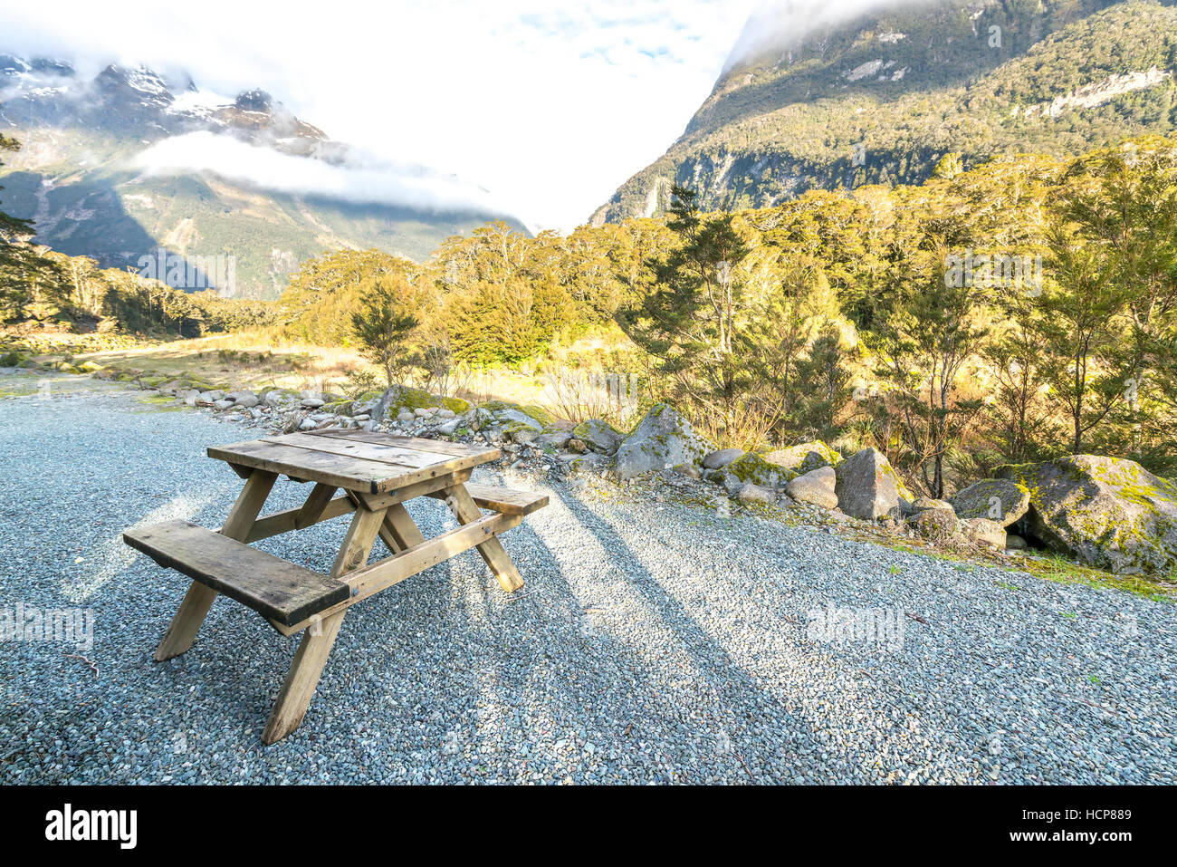 Wooden bench with mountain background Stock Photo - Alamy