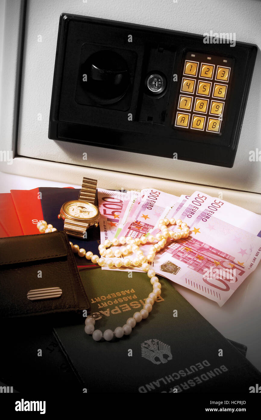 Valuables in front of a safe Stock Photo - Alamy