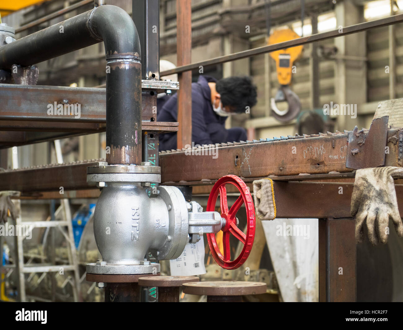 Metal pipes and a valve during production at a large mechanical ...