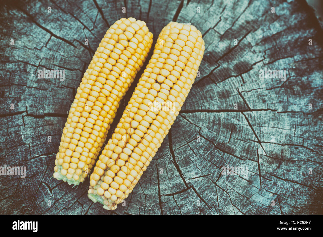 Corn cob on old wooden table Stock Photo - Alamy