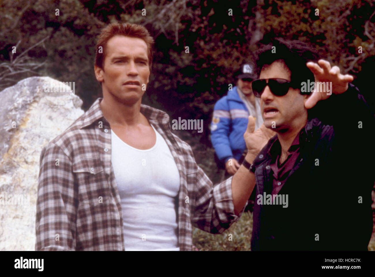 COMMANDO, Arnold Schwarzenegger, director Mark Lester, on set, 1985. TM ...
