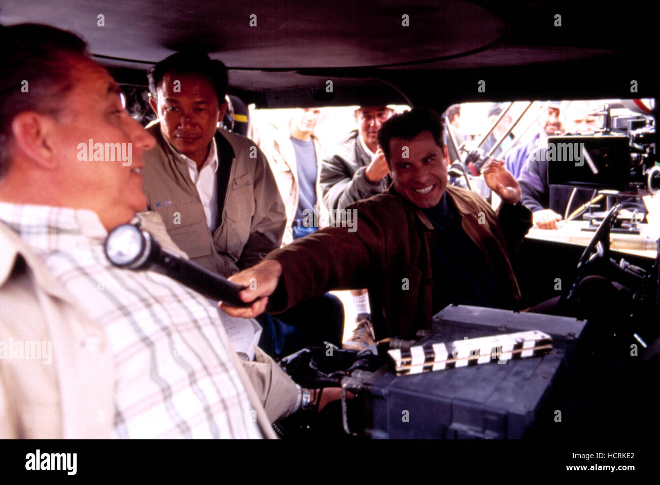 Director John Woo, John Travolta rehearing a scene on the set of BROKEN ...