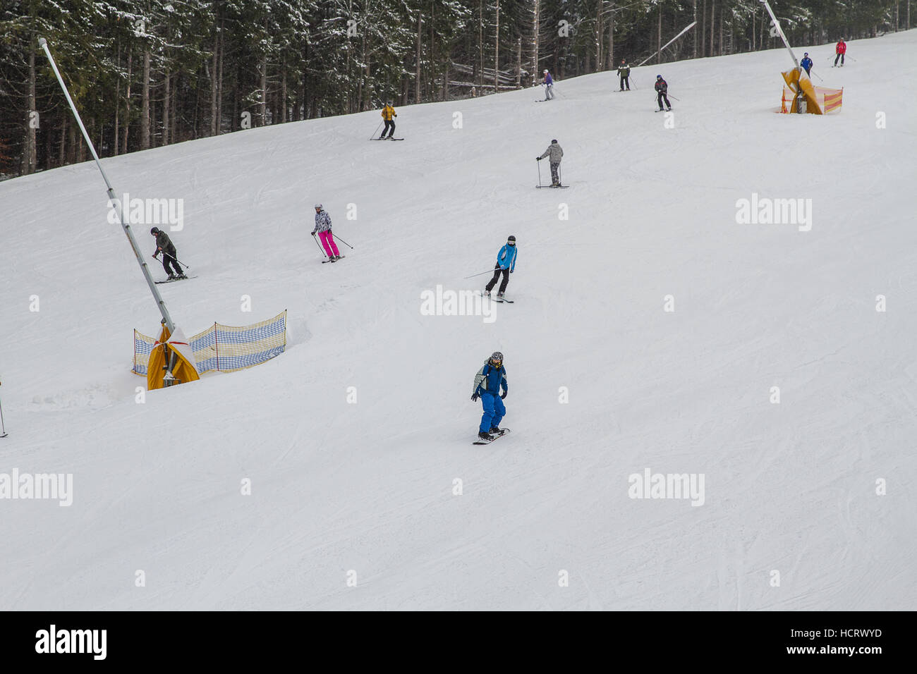 Skiers and snowboarders enjoying on slopes of ski resort Bukovel ...