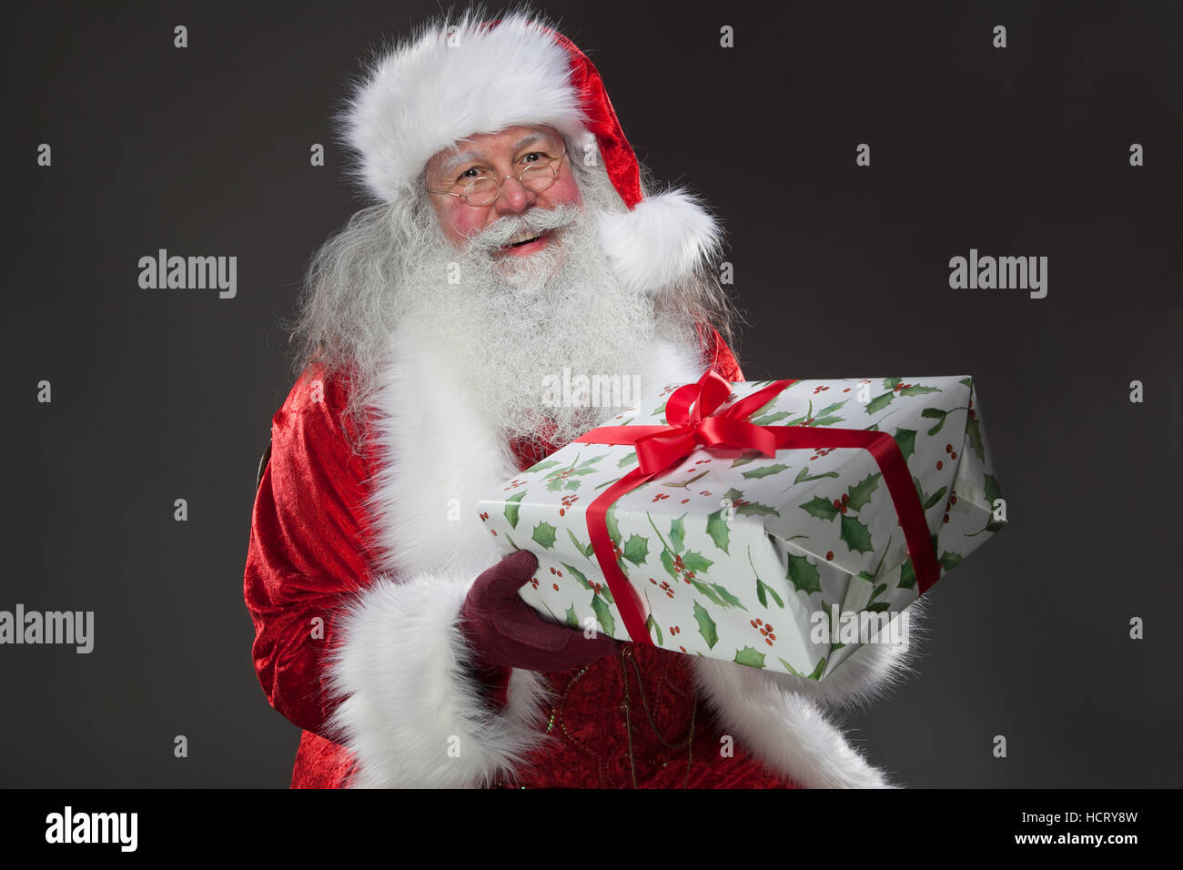 Santa Claus gives a present Stock Photo - Alamy