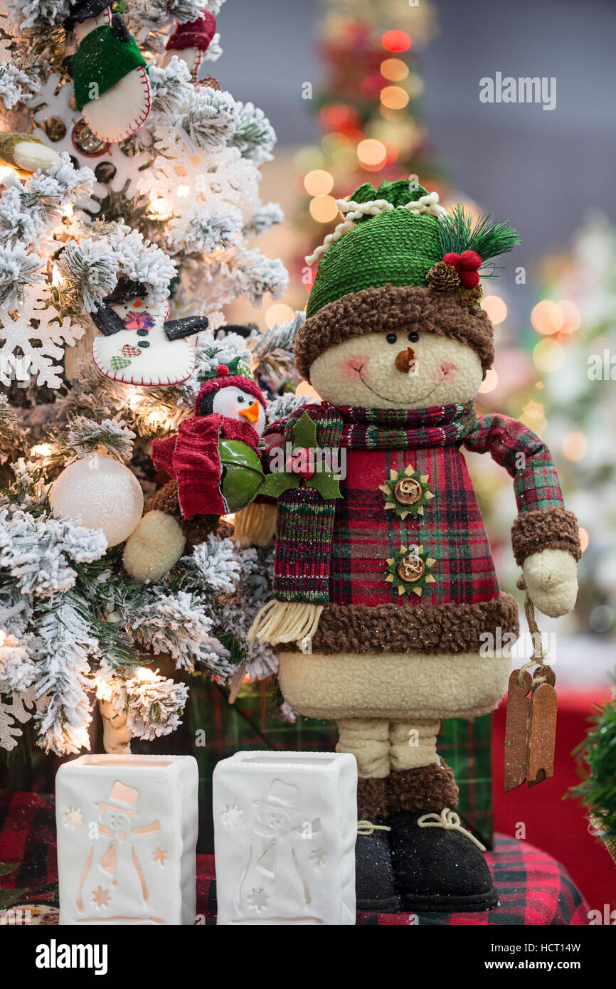 Christmas snowman displayed in front of tree and decorations Stock ...