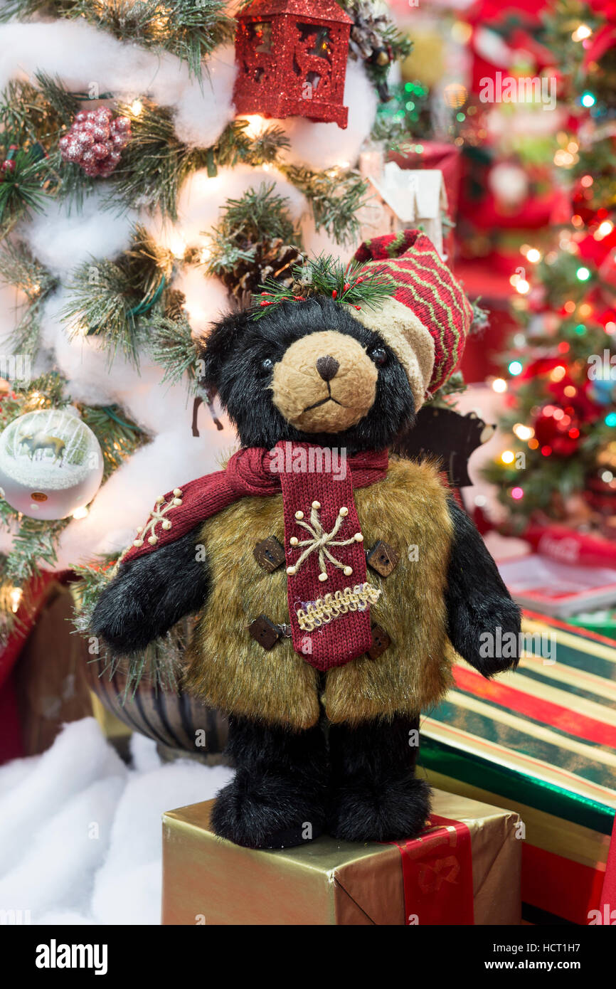 Christmas teddy bear displayed in front of tree and decorations Stock ...