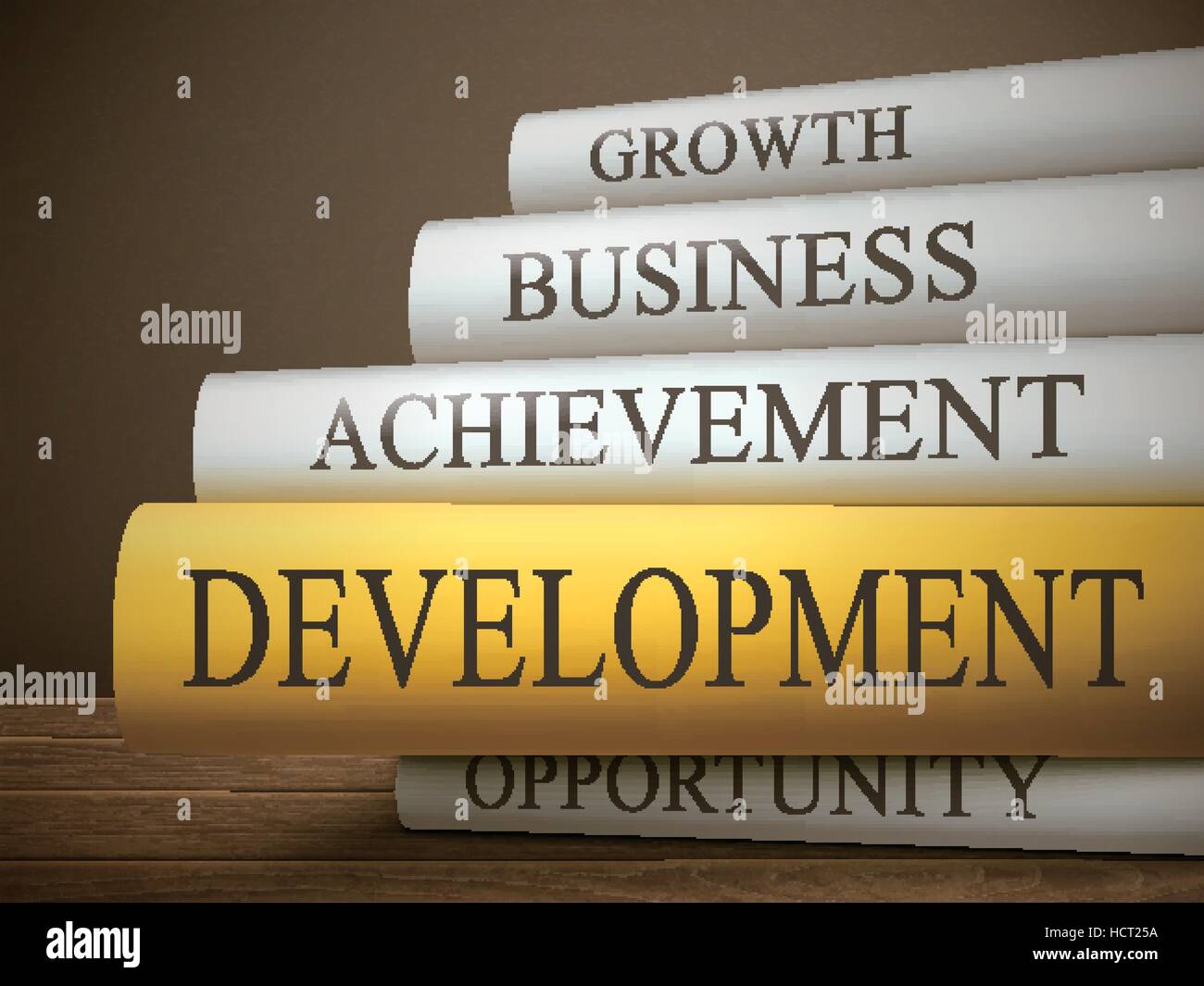 book title of development isolated on a wooden table over dark ...
