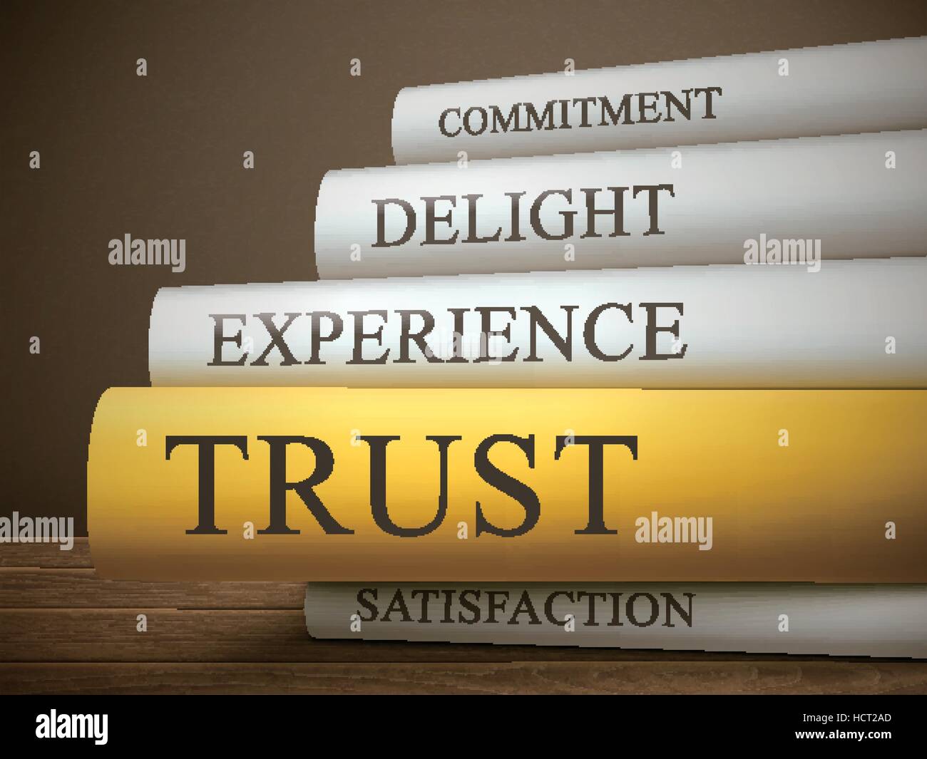 book title of trust isolated on a wooden table over dark background ...
