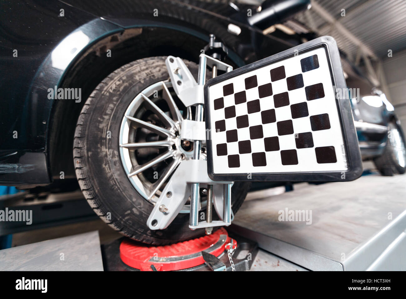 Car on stand with sensors wheels for alignment camber check in workshop ...