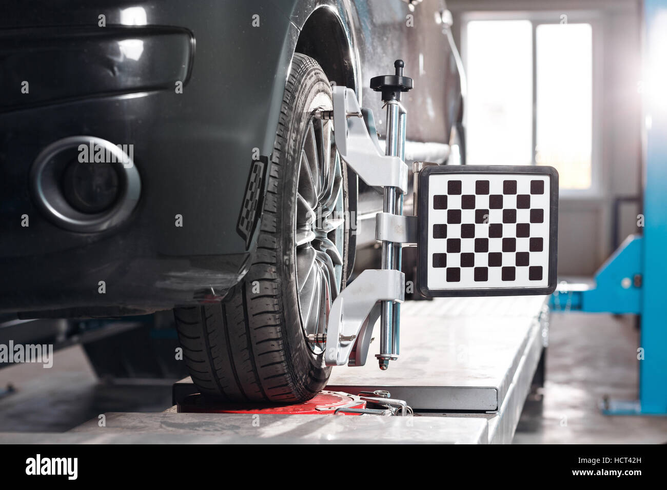 Car on stand with sensors wheels for alignment camber check in workshop ...