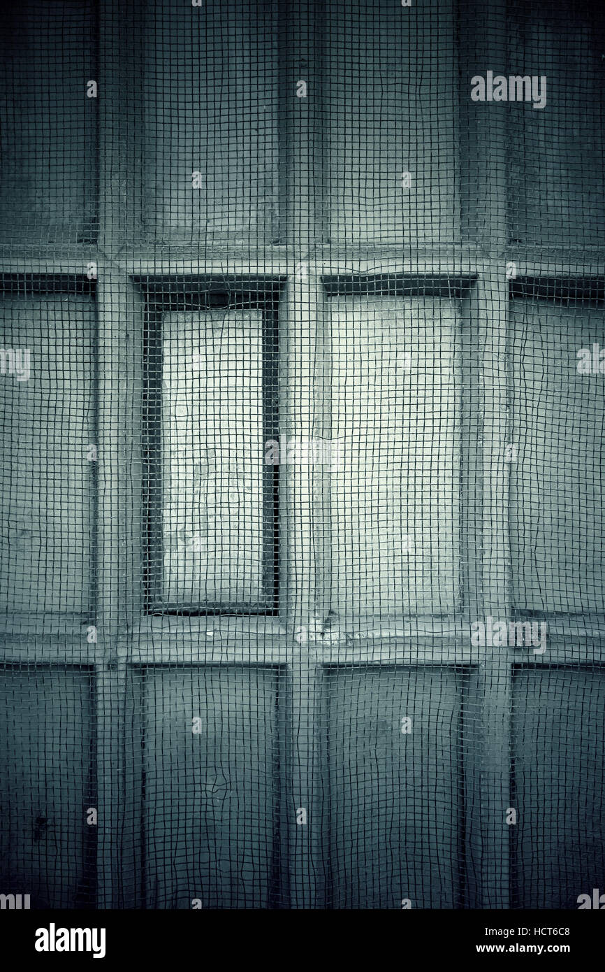 Cement closed window, detail of window protected by a metal fence ...