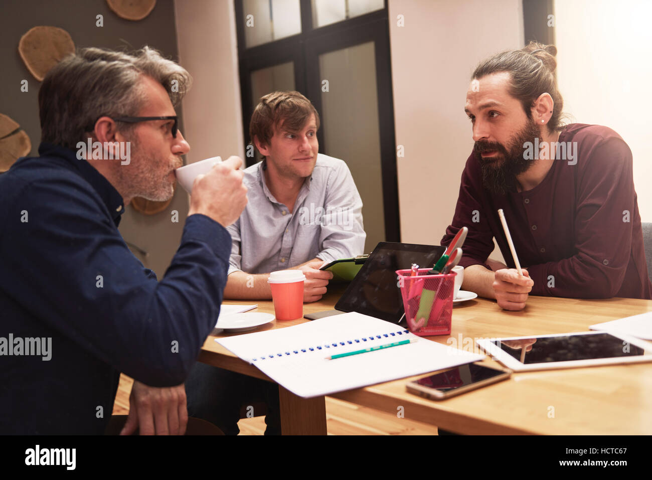 Men working about new project Stock Photo - Alamy