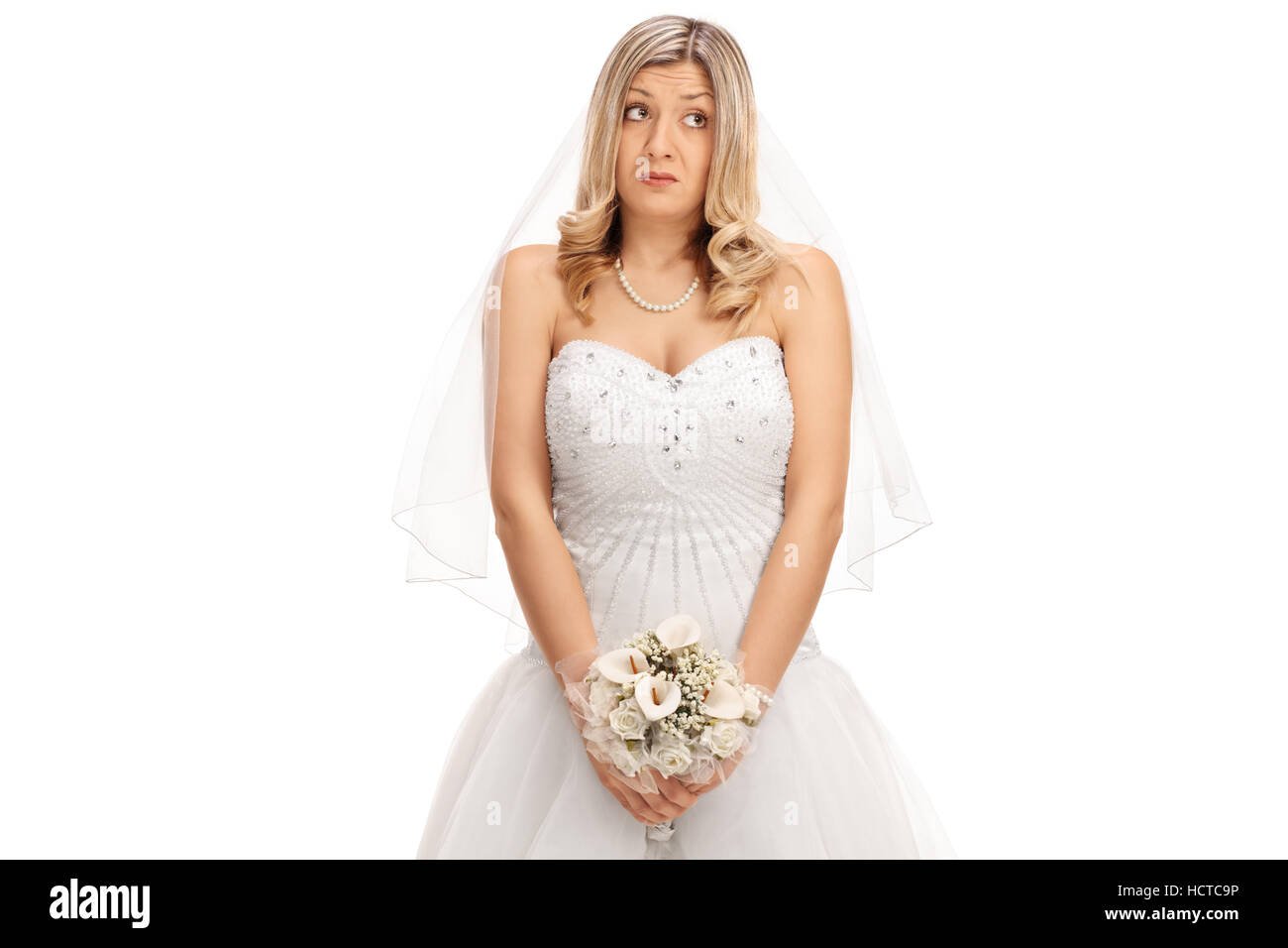 Embarrassed bride with a wedding flower isolated on white background ...