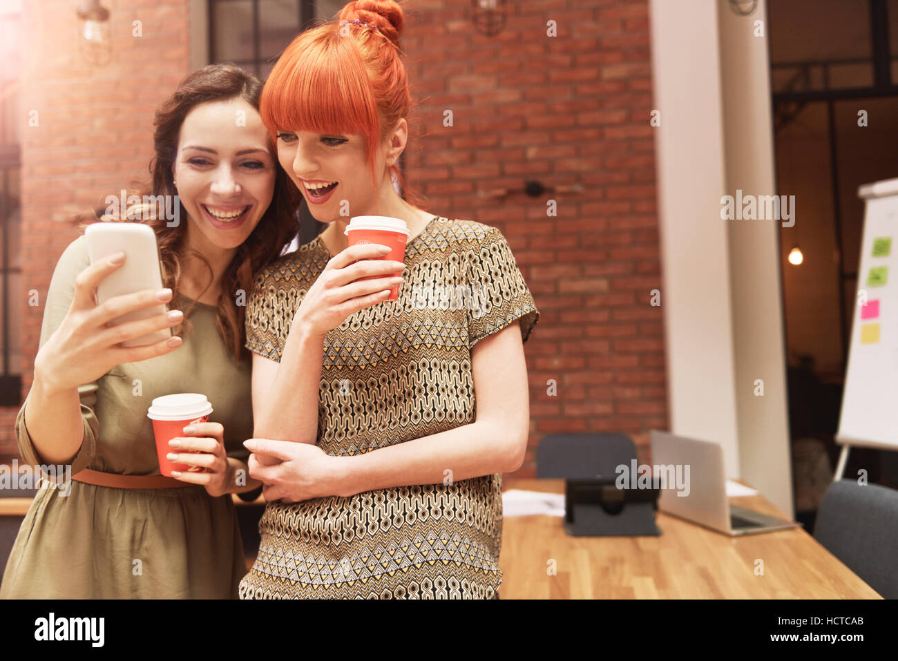 Checking funny joke during the coffee break Stock Photo - Alamy
