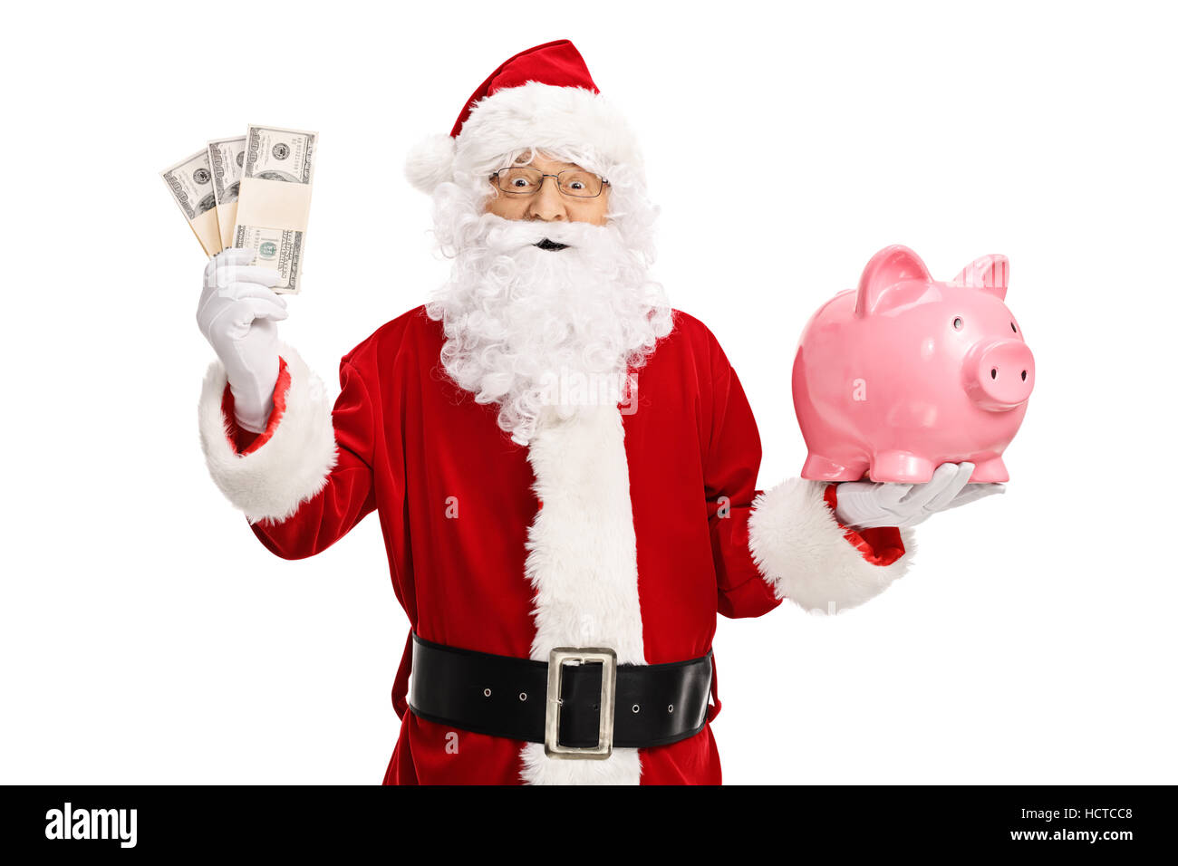 Santa claus holding money bundles and a piggybank isolated on white ...