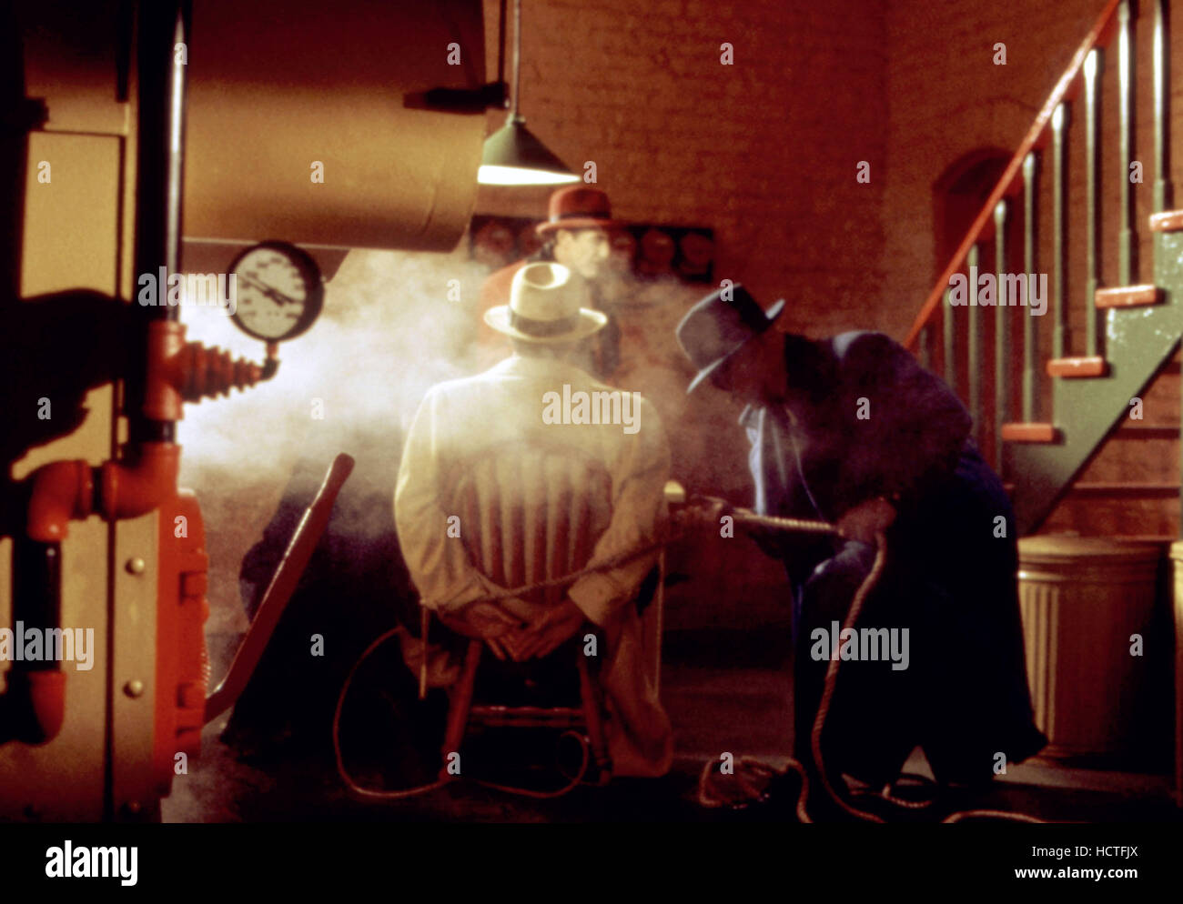 DICK TRACY, Warren Beatty (in chair), Al Pacino (standing behind Beatty ...