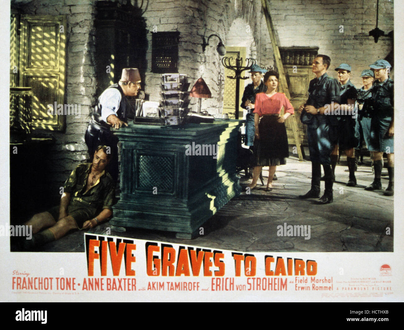 FIVE GRAVES TO CAIRO, Franchot Tone (on floor), Akim Tamiroff (behind ...
