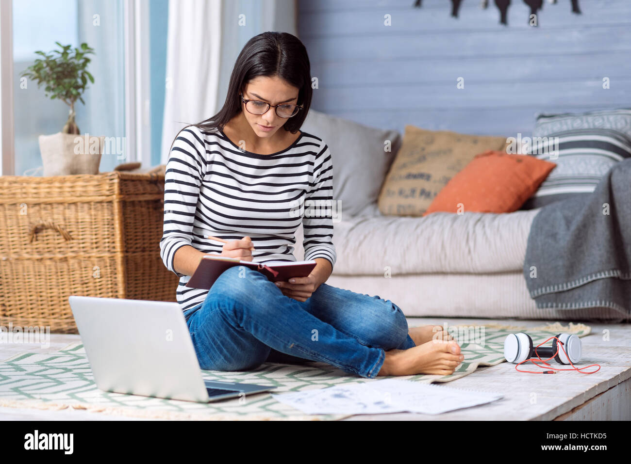 Involved young lady making notes in the bedroom Stock Photo - Alamy