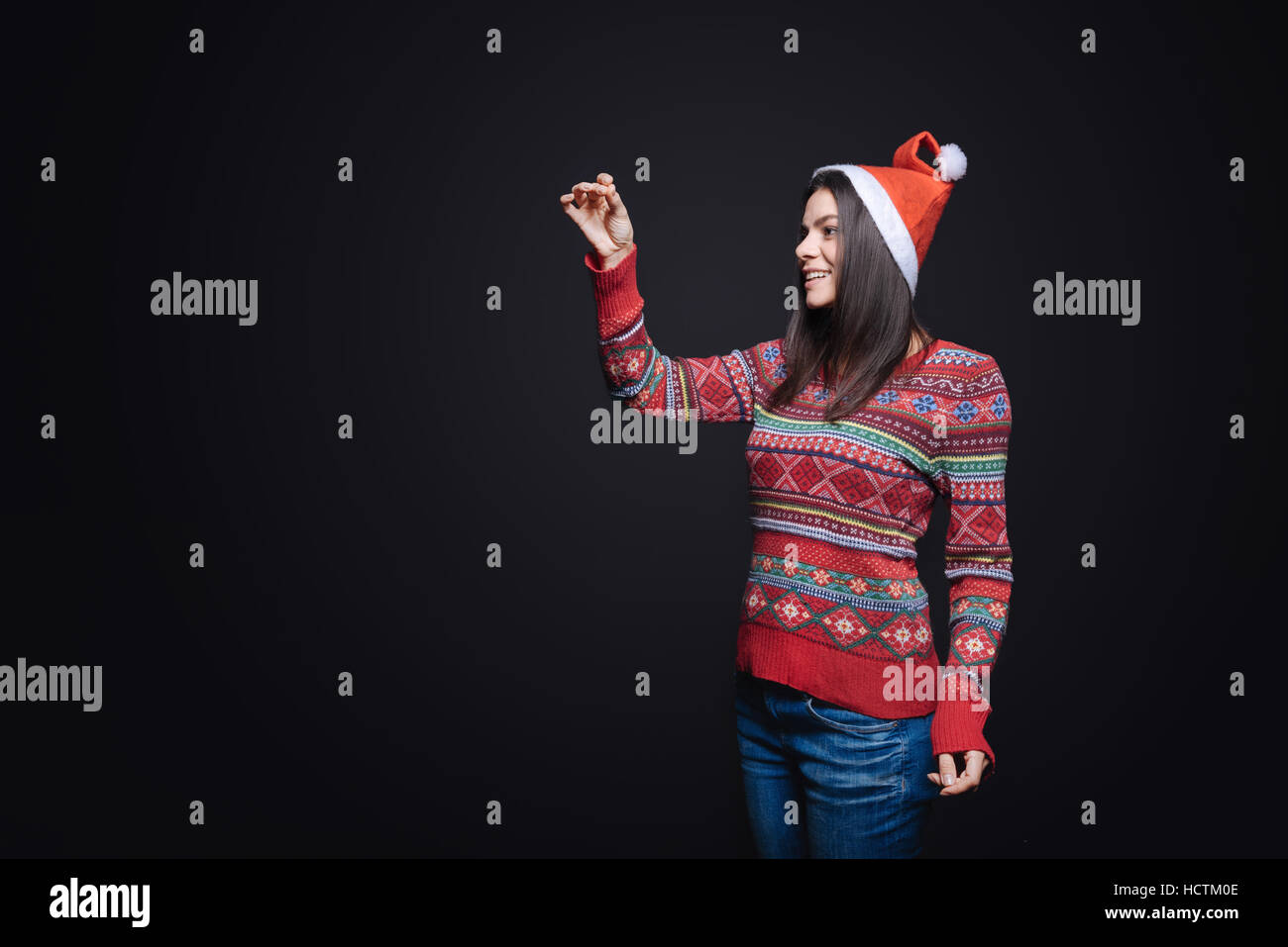 Delighted pleasant girl standing in the studio Stock Photo - Alamy