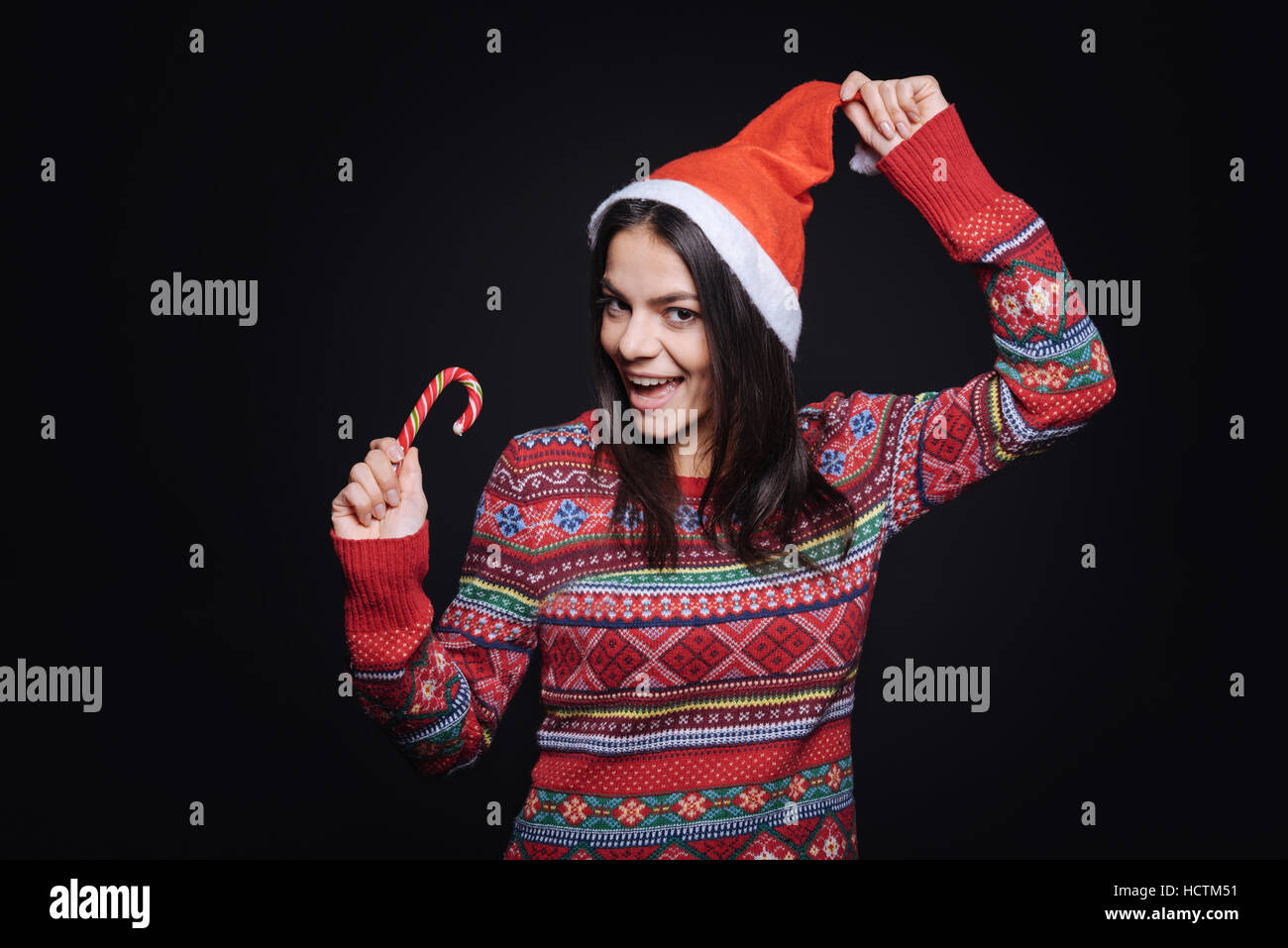 Amused girl holding the candy stick and having fun Stock Photo - Alamy