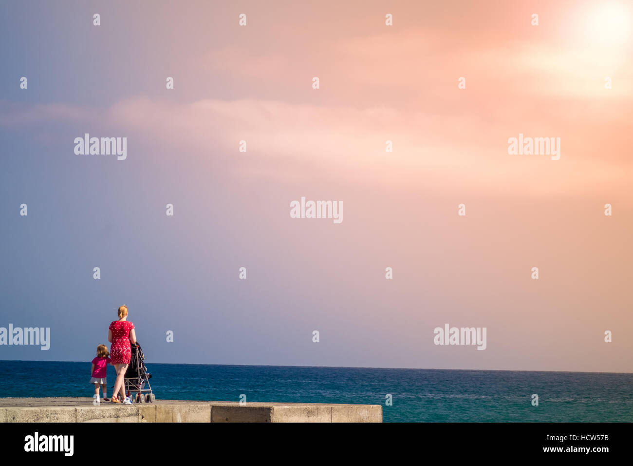 Mother walking on a pier pushing her pram with her baby Stock Photo - Alamy