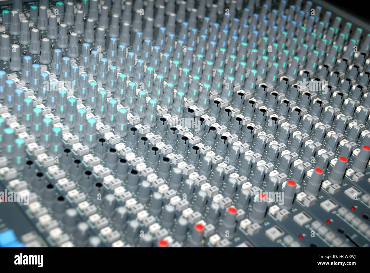 Audio mixing console in a recording studio. Faders and knobs of a sound ...