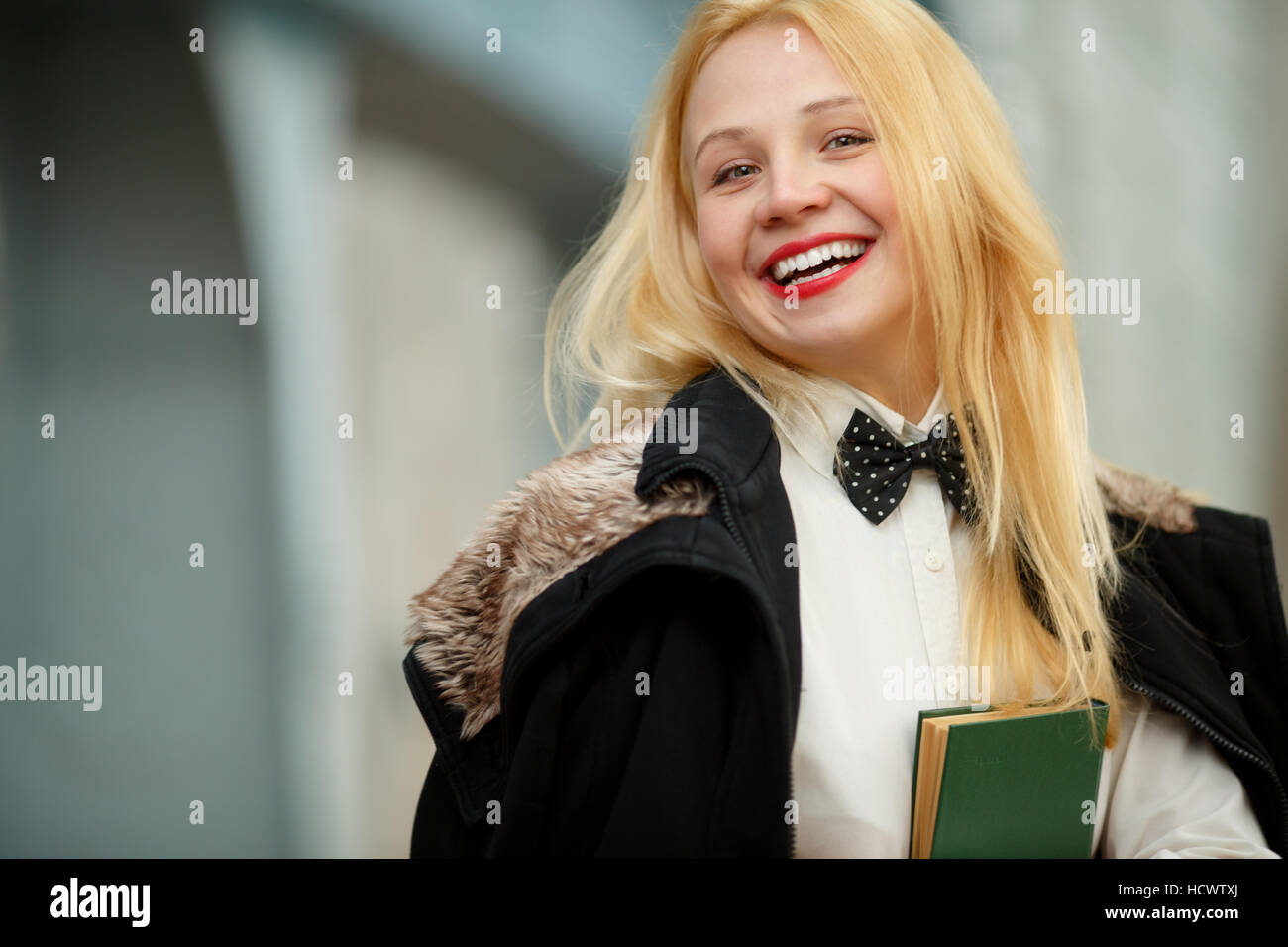 Happy ginger in black coat in office Stock Photo - Alamy