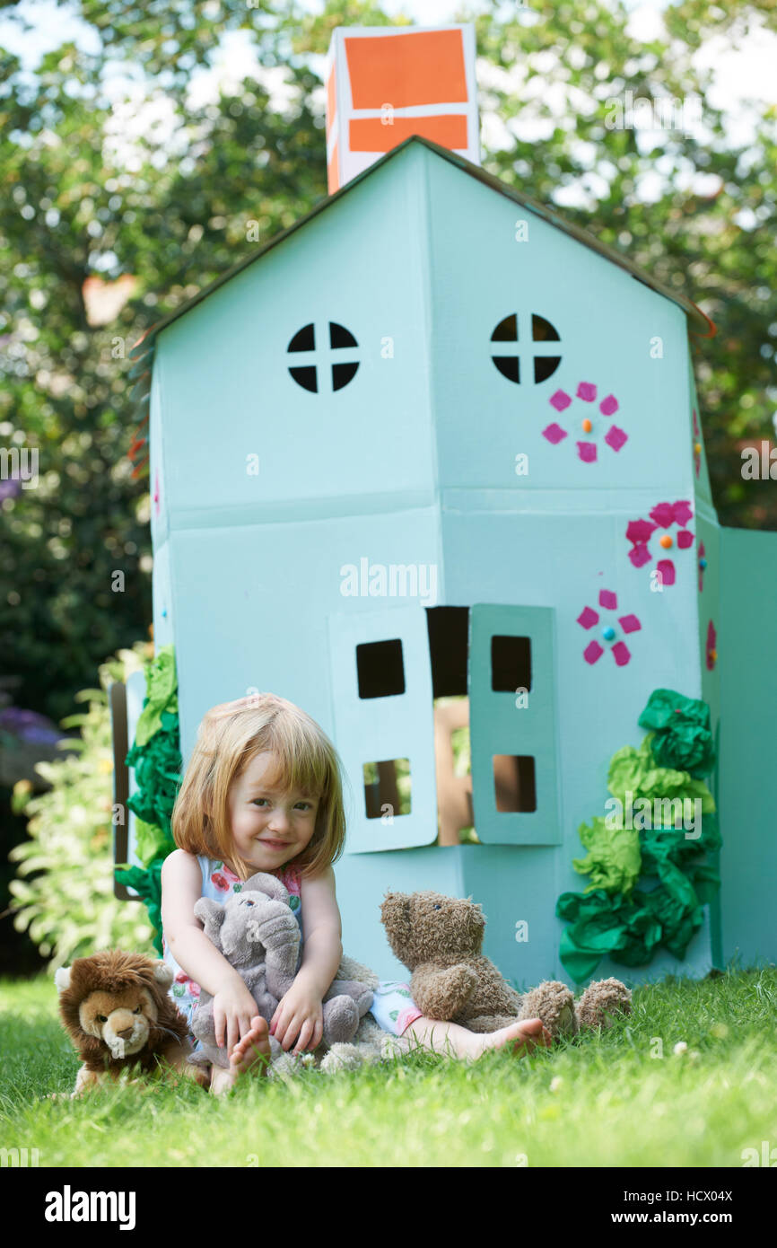 Little Girl Playing In Home Made Cardboard House Stock Photo - Alamy