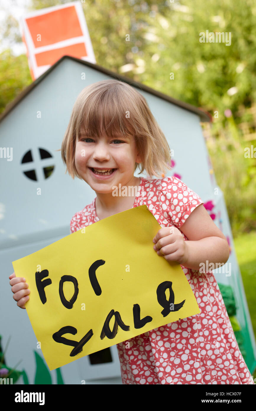 Little Girl Holding For Sale Sign Outside Play House Stock Photo - Alamy
